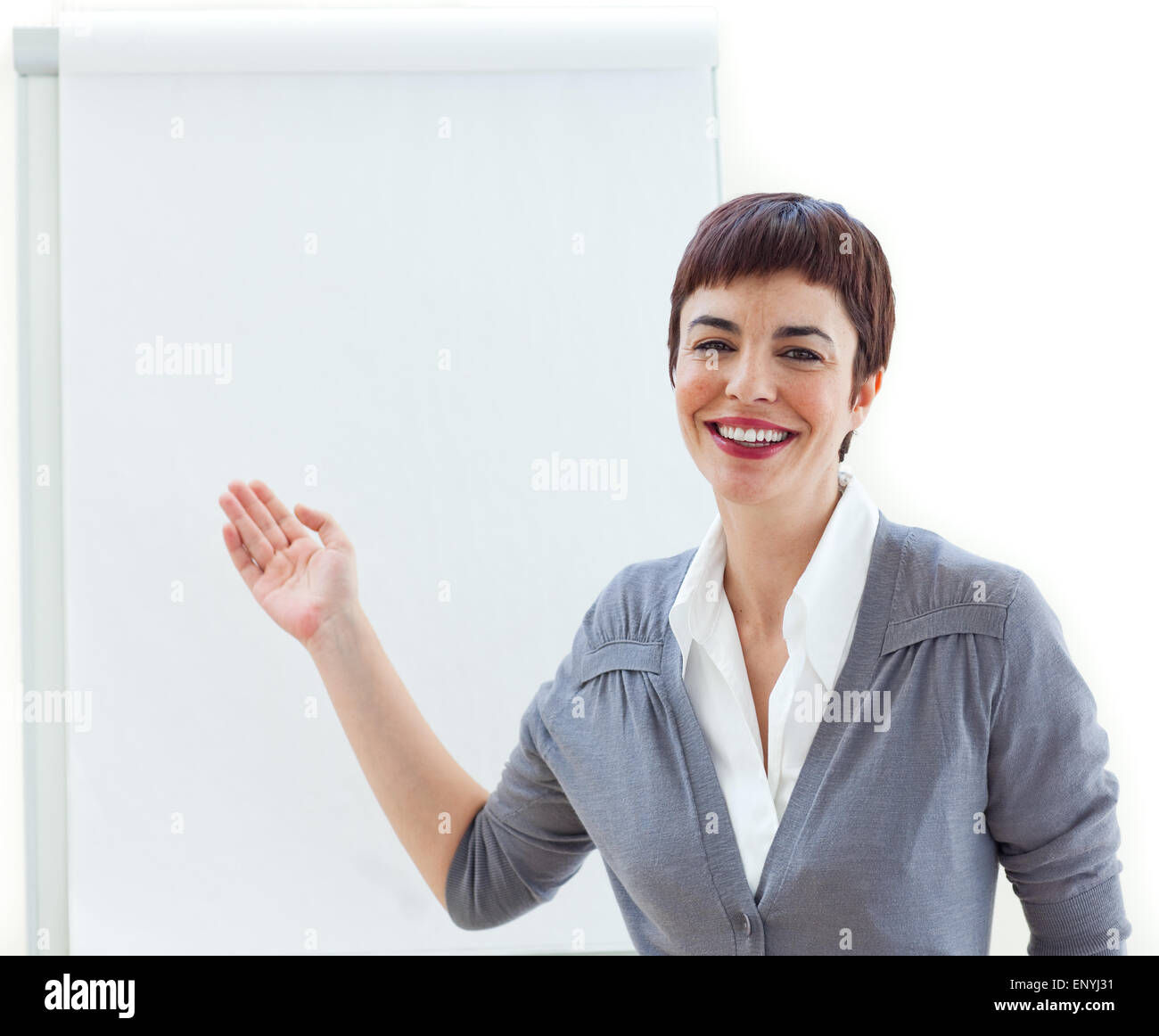 Assertive young businesswoman ponting at a board Stock Photo - Alamy