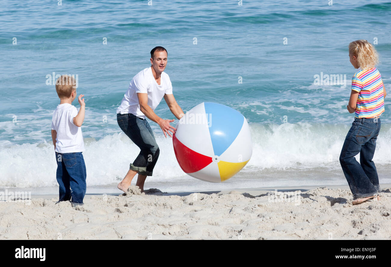 Happy father and his children playing with a ball Stock Photo - Alamy