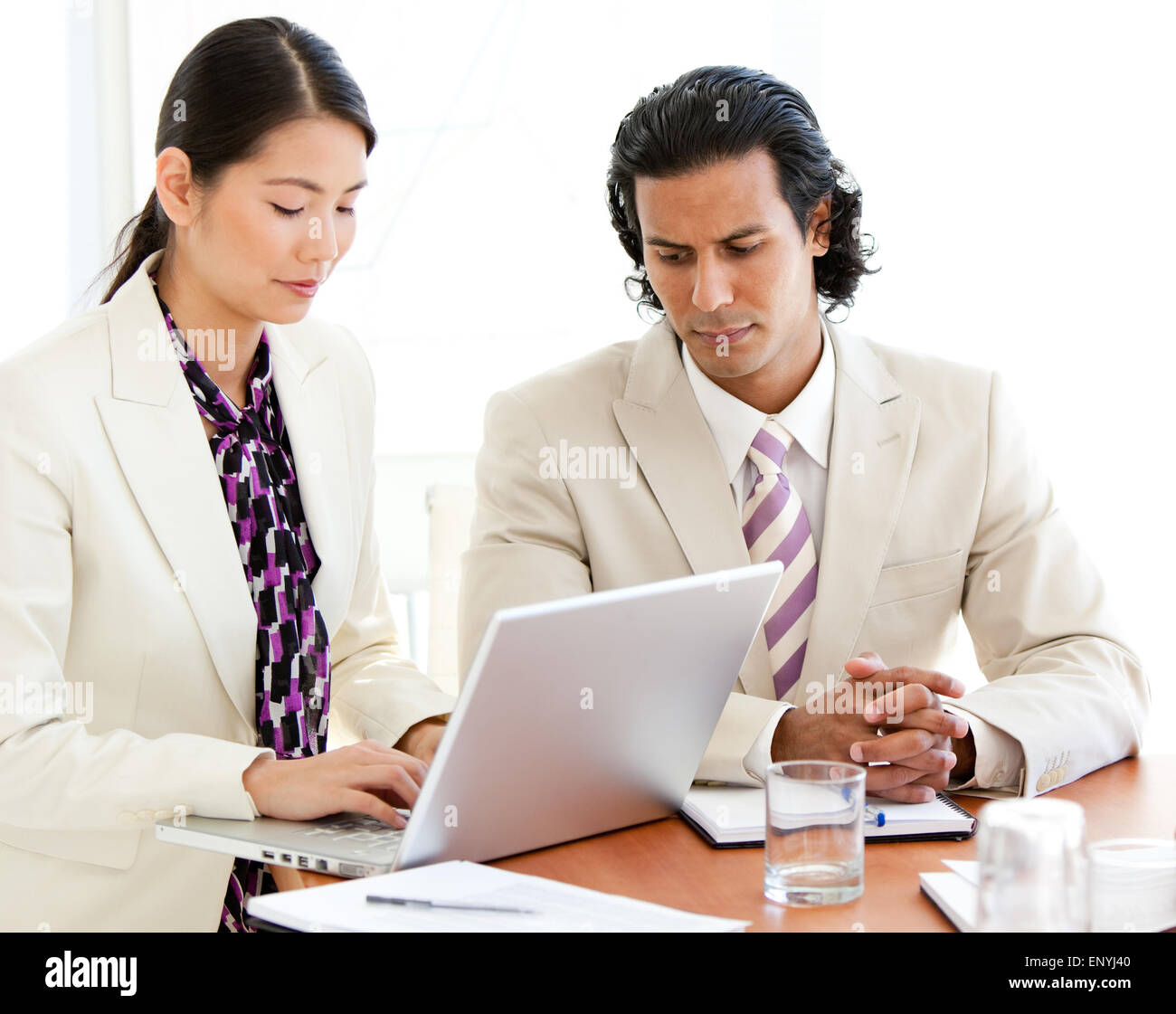 Concentrated business people working at a laptop Stock Photo - Alamy