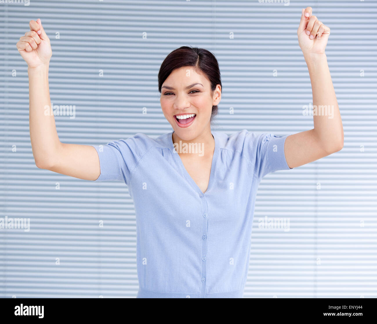 Successful businesswoman punching the air in celebration Stock Photo ...
