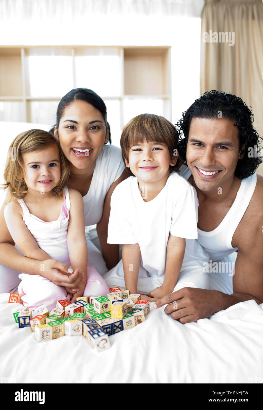 Happy family having fun with cube toys Stock Photo - Alamy