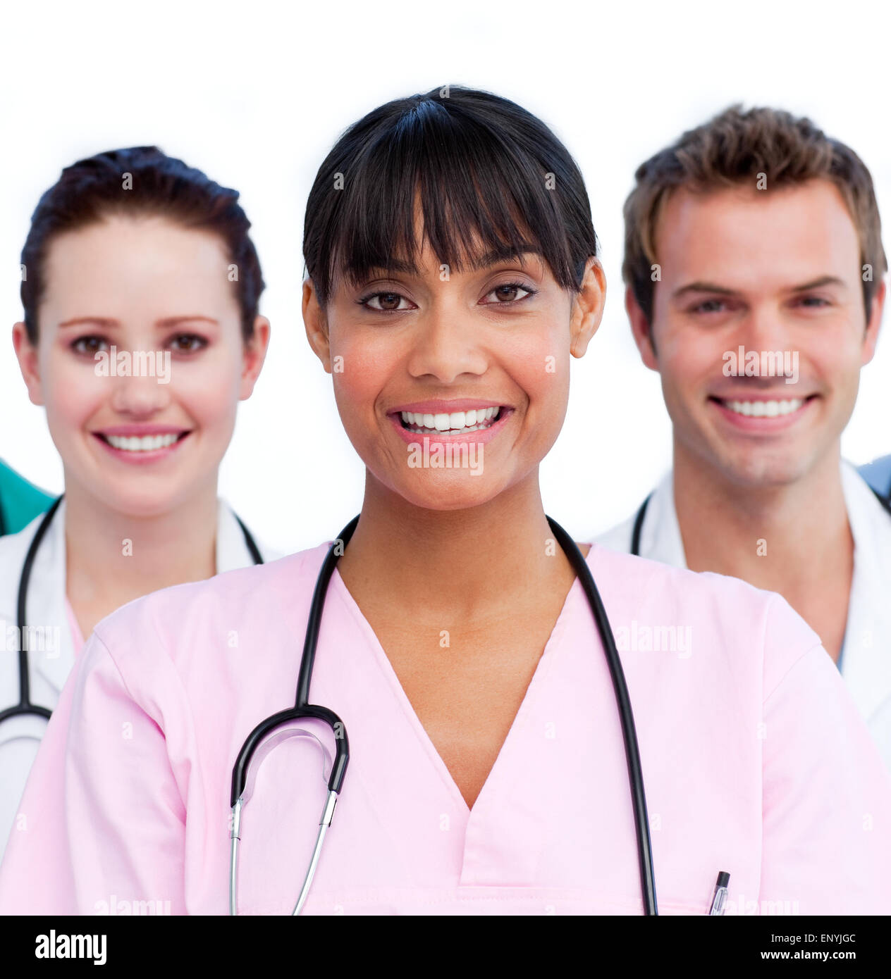 Portrait of a doctor and her medical team against a white background ...