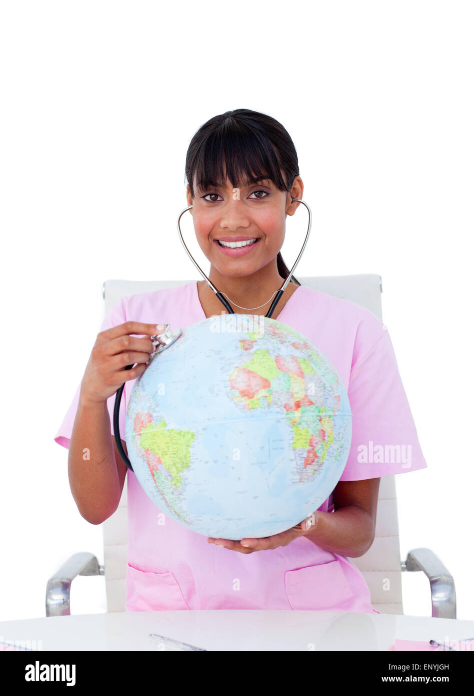 Portrait of an ambitious doctor examining a terrestrial globe against a ...