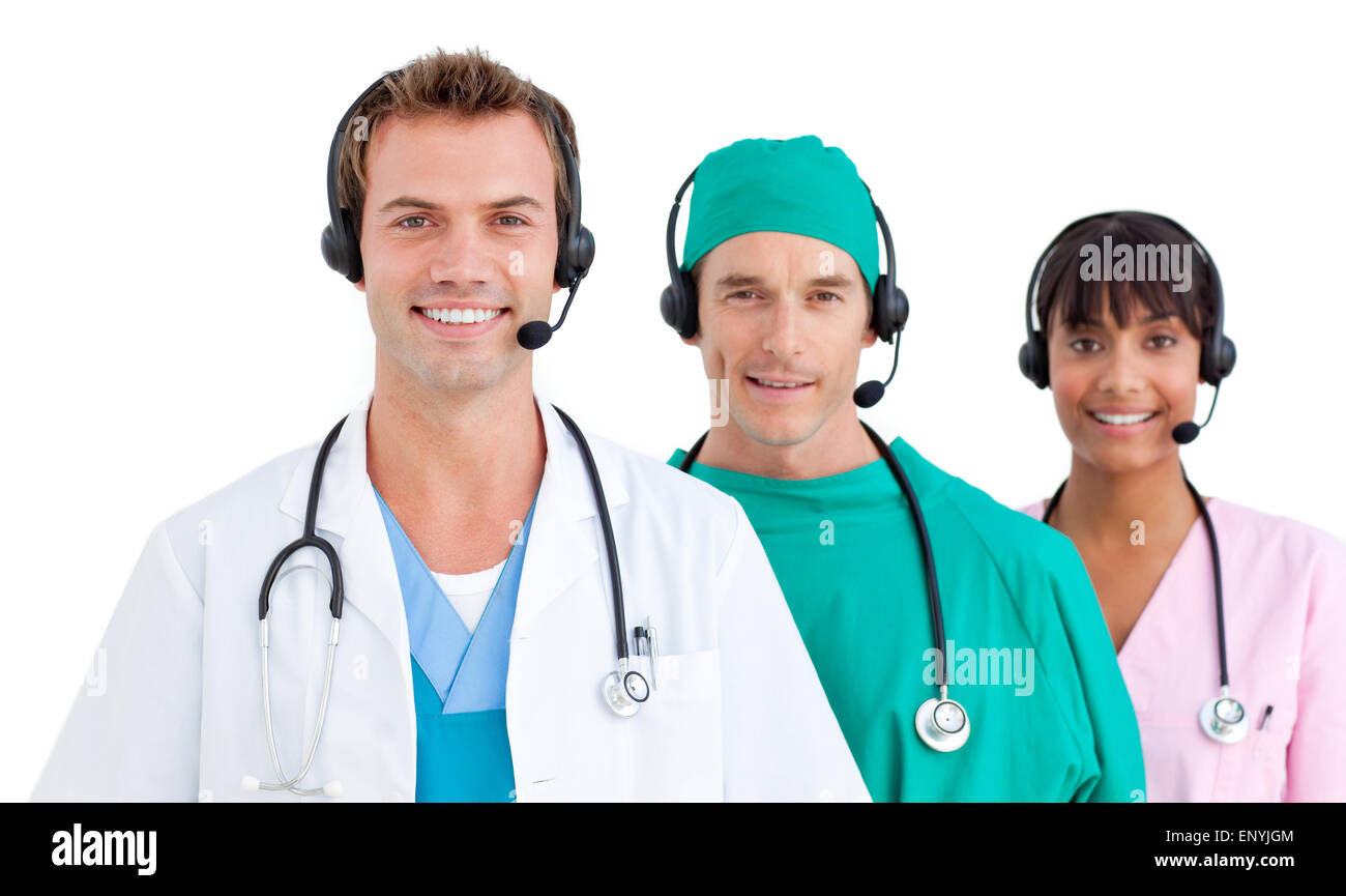 Smiling medical team using headsets against a white background Stock ...