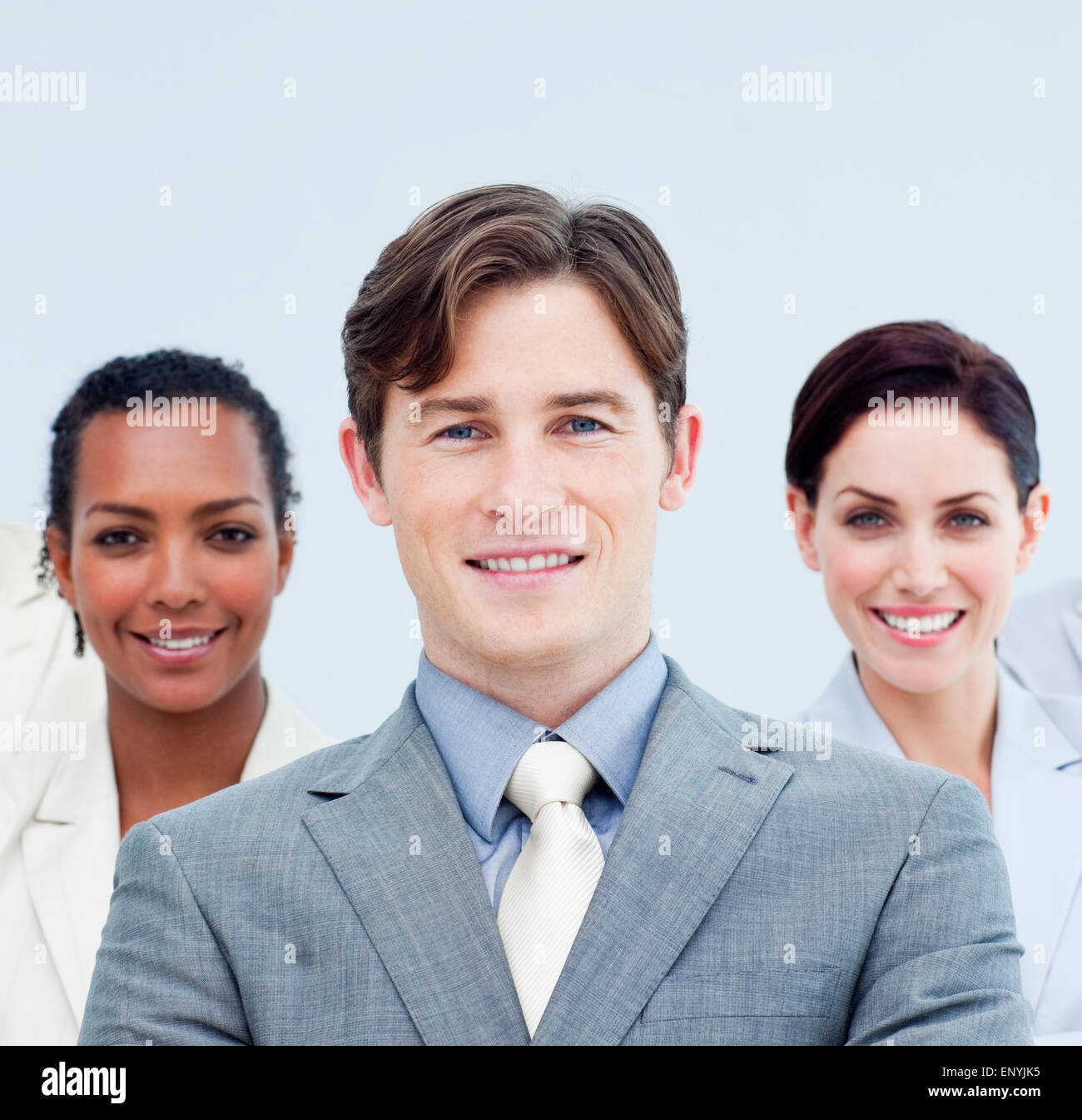 Smiling business people standing with folded arms Stock Photo - Alamy