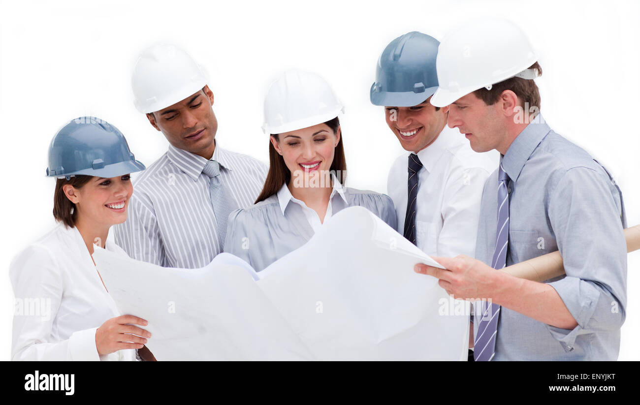 Smiling architects studying a blueprint against a white background ...