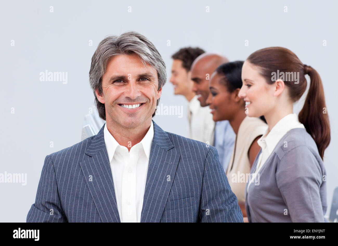 Smiling manager in front of his team Stock Photo - Alamy