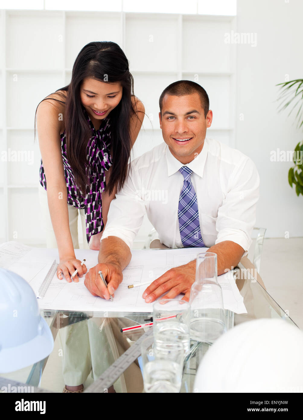 A diverse group of architects reviewing blueprints Stock Photo - Alamy