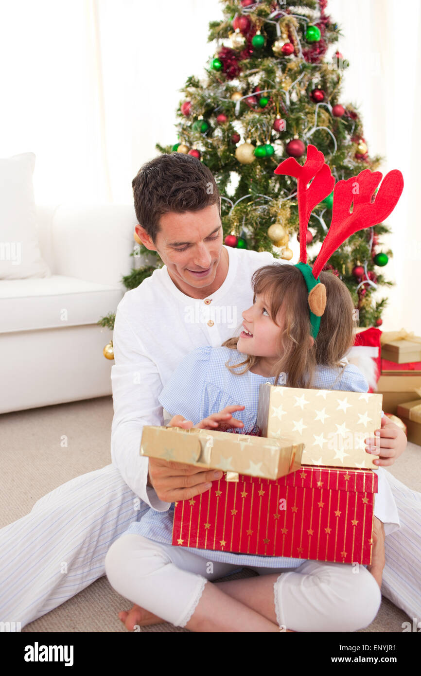 Smiling father and his daughter opening Christmas gifts Stock Photo - Alamy