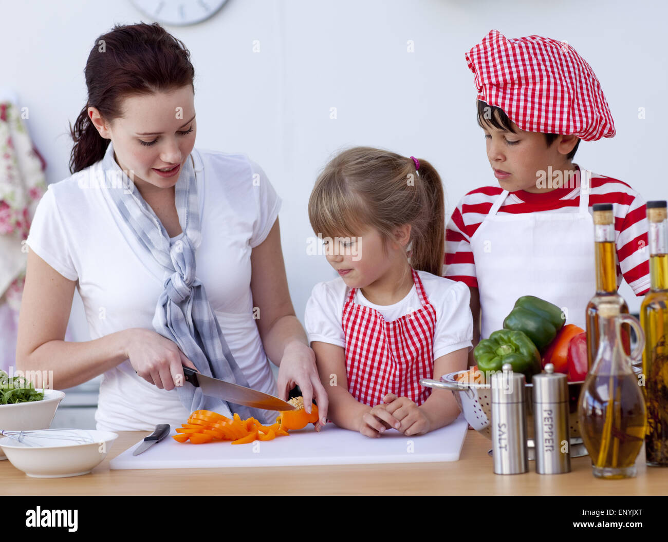 Children helping mother cooking in the kitchen Stock Photo - Alamy