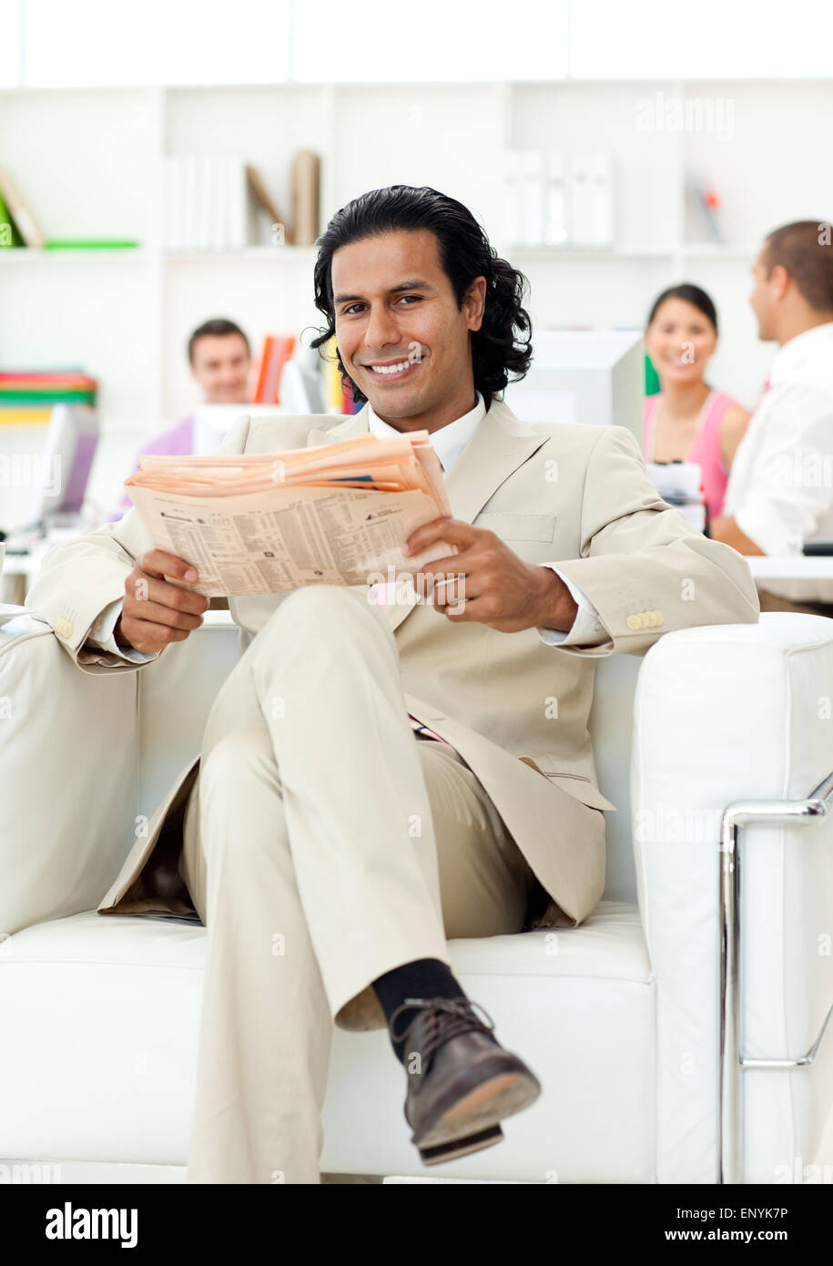 Self-assured manager reading a newspaper Stock Photo - Alamy