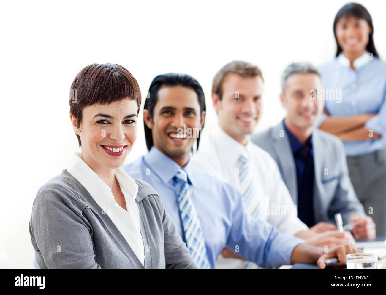Smiling business co-workers sitting in a line Stock Photo - Alamy
