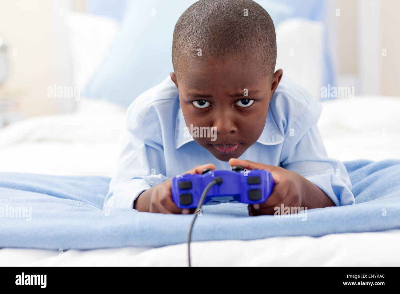 Happy little boy playing video game Stock Photo - Alamy