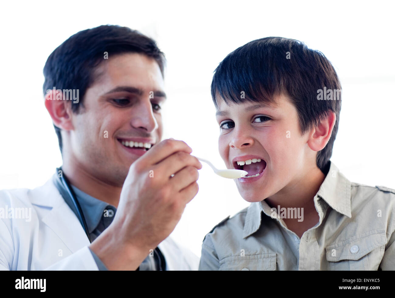 Assertive doctor giving medicine to a little boy Stock Photo - Alamy