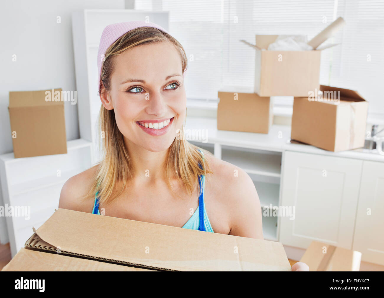 Positive woman carrying boxes at home Stock Photo - Alamy