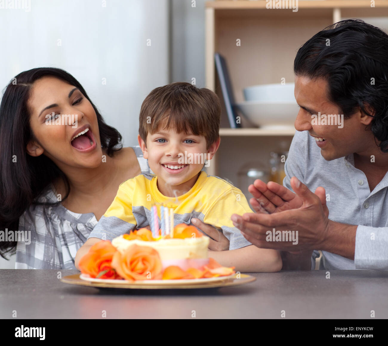 Smiling little boy celebrating his birthday with his parents Stock ...