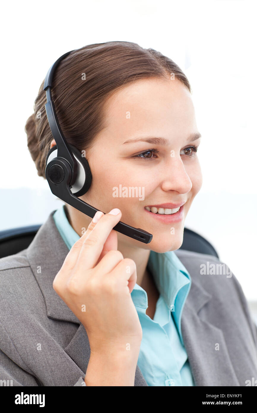 Pretty representative on the phone with earpiece Stock Photo - Alamy
