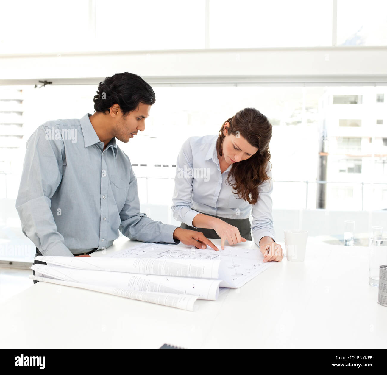 Two business people looking at a new project Stock Photo - Alamy