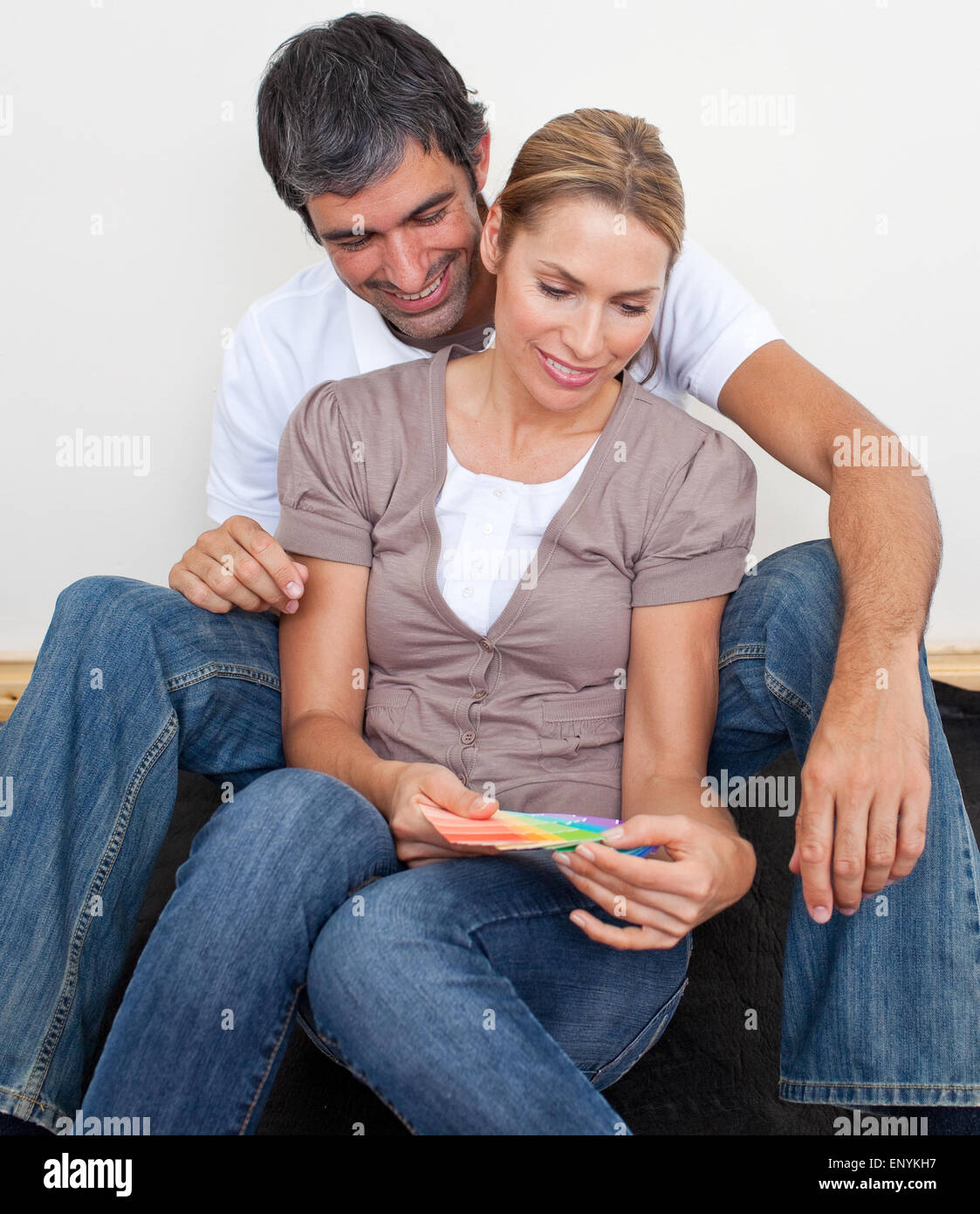Couple choosing color to paint their new appartment Stock Photo - Alamy