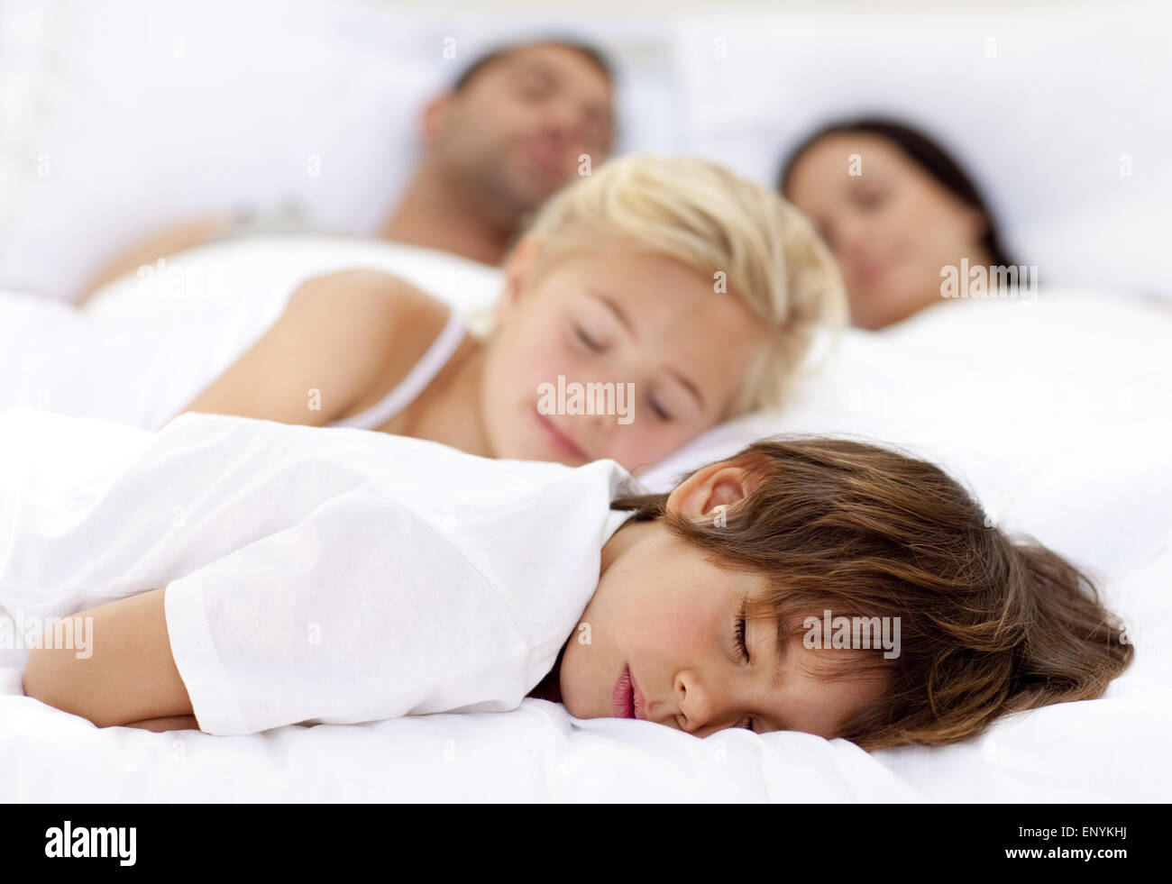 Children sleeping with his parents Stock Photo - Alamy