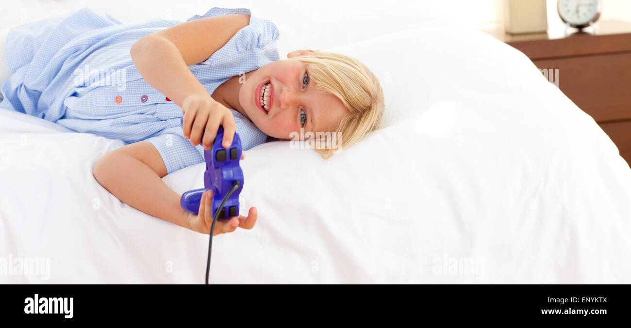 Adorable little girl playing video game Stock Photo - Alamy