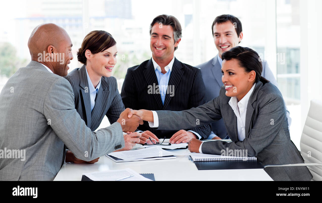 Happy business people closing a deal Stock Photo - Alamy