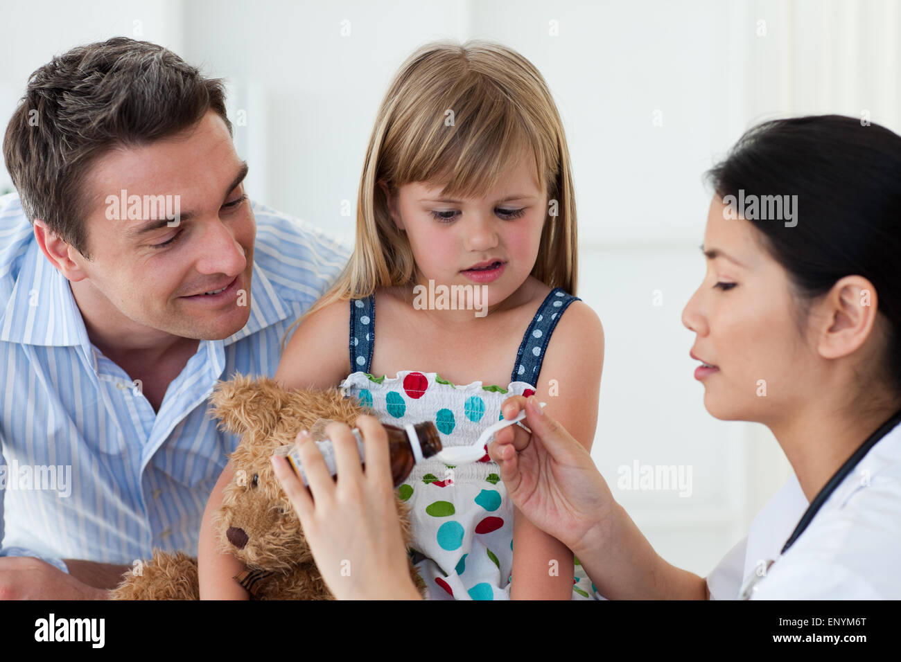 Serious female doctor giving medecne to a little girl Stock Photo - Alamy