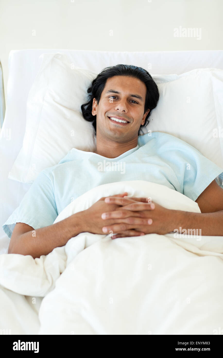 Portrait of a smiling patient lying in a hospital bed Stock Photo - Alamy