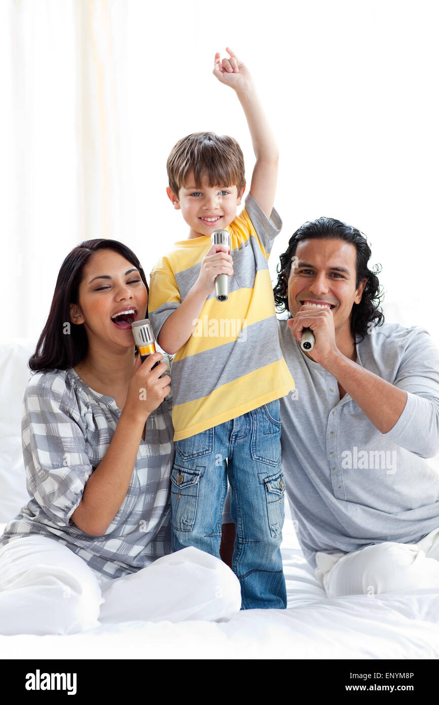 Lively young family singing with microphones Stock Photo - Alamy