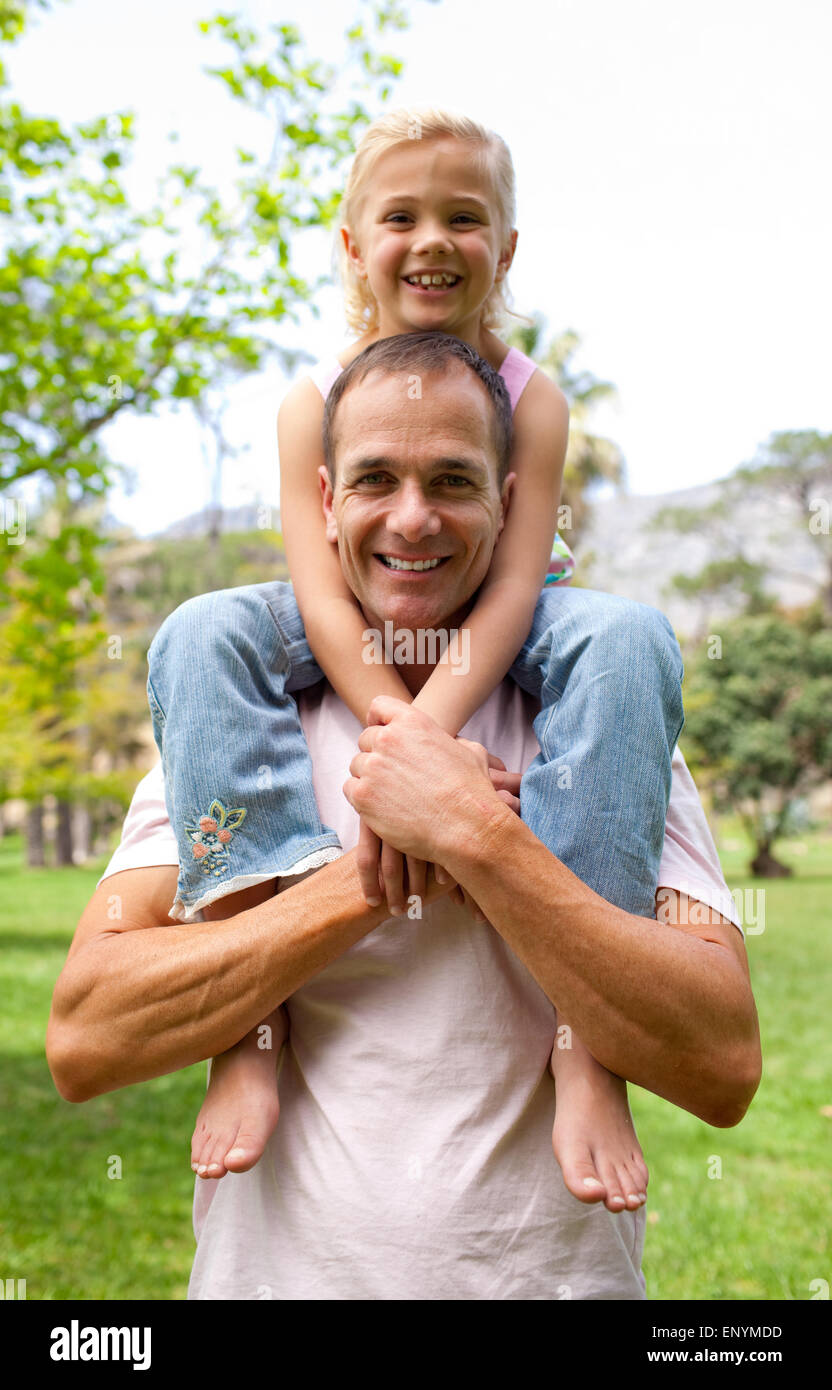Smiling father giving his daughter piggy-back ride Stock Photo - Alamy