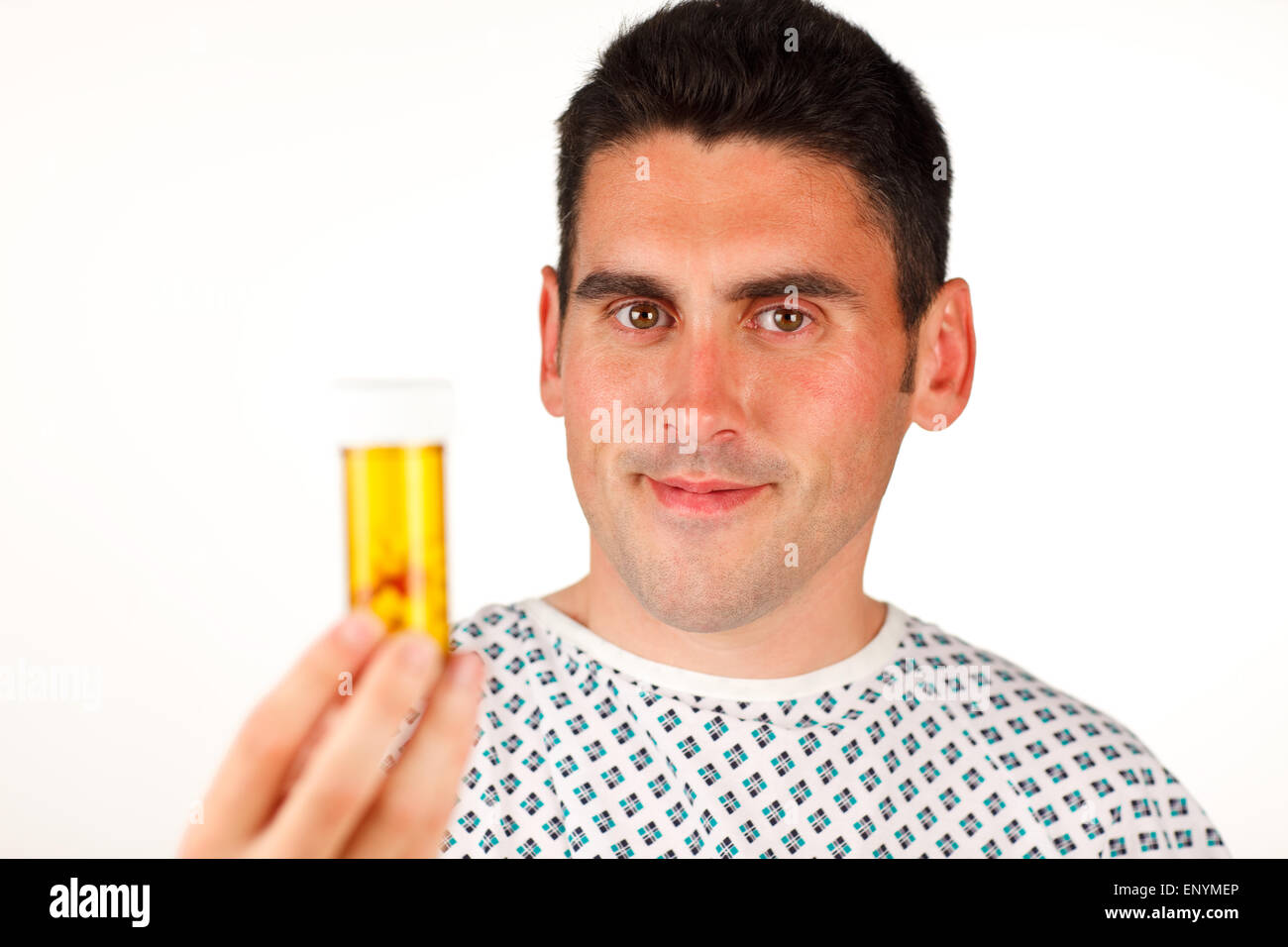 Patient holding pills and smiling Stock Photo - Alamy