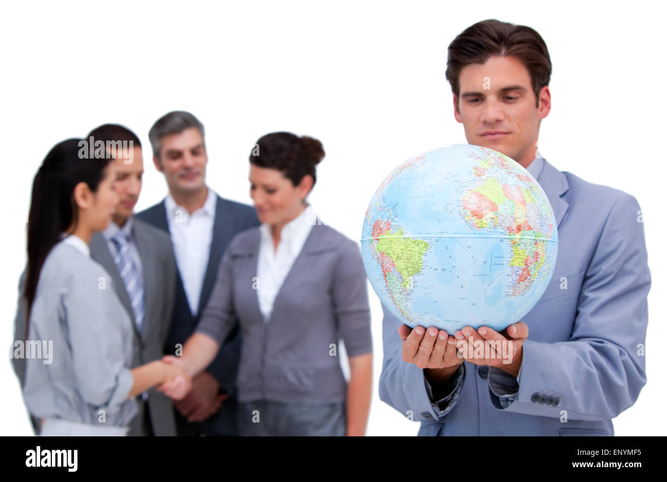 Handsome business man and his team looking at a terrestrial globe ...