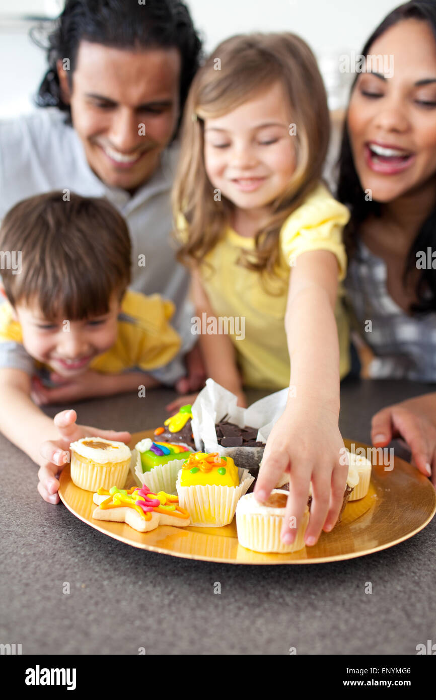 Joyful family eating cookies Stock Photo - Alamy