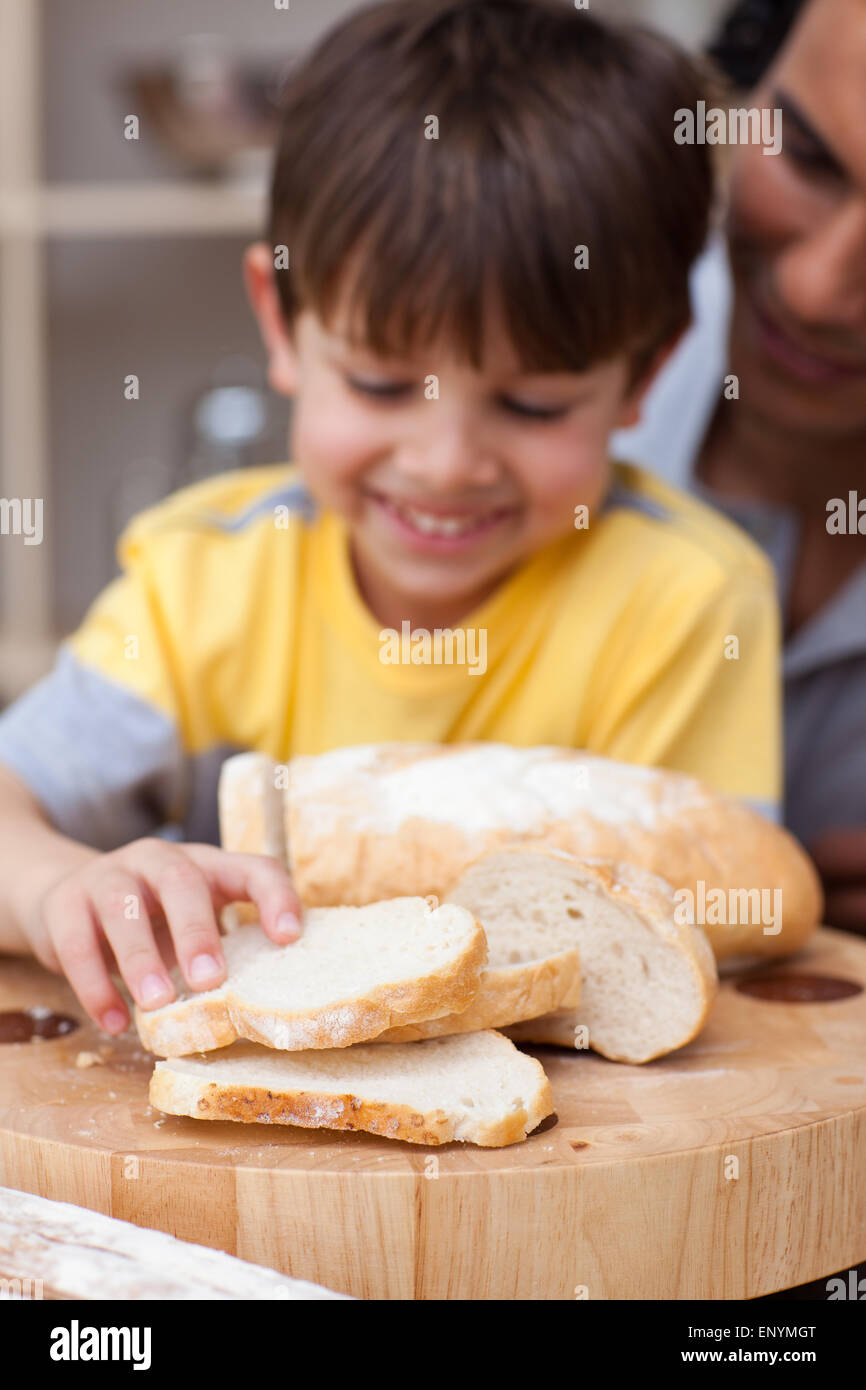 Adorable little boy eating bread with his father Stock Photo - Alamy