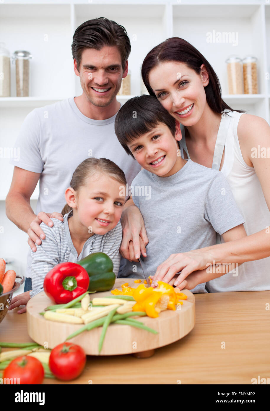 Portrait of happy parents cooking with their children Stock Photo - Alamy