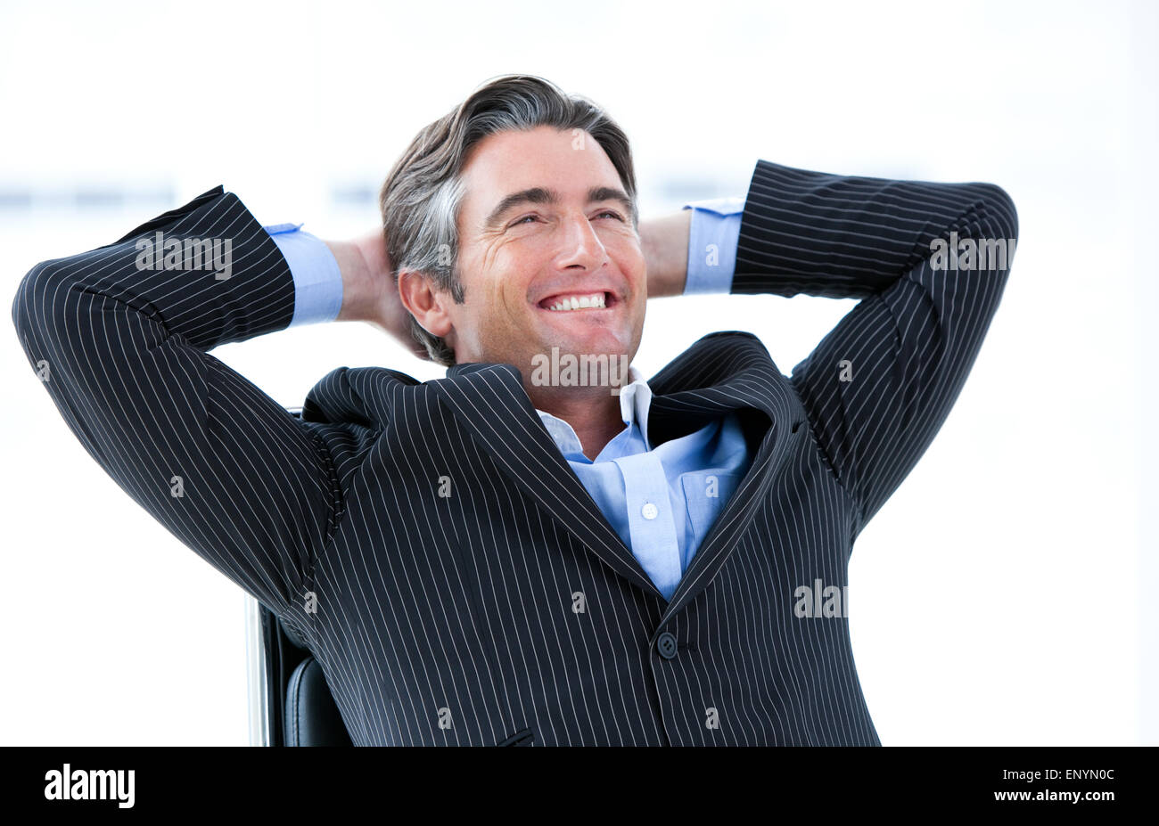 Laughing male executive thinking about his success Stock Photo - Alamy