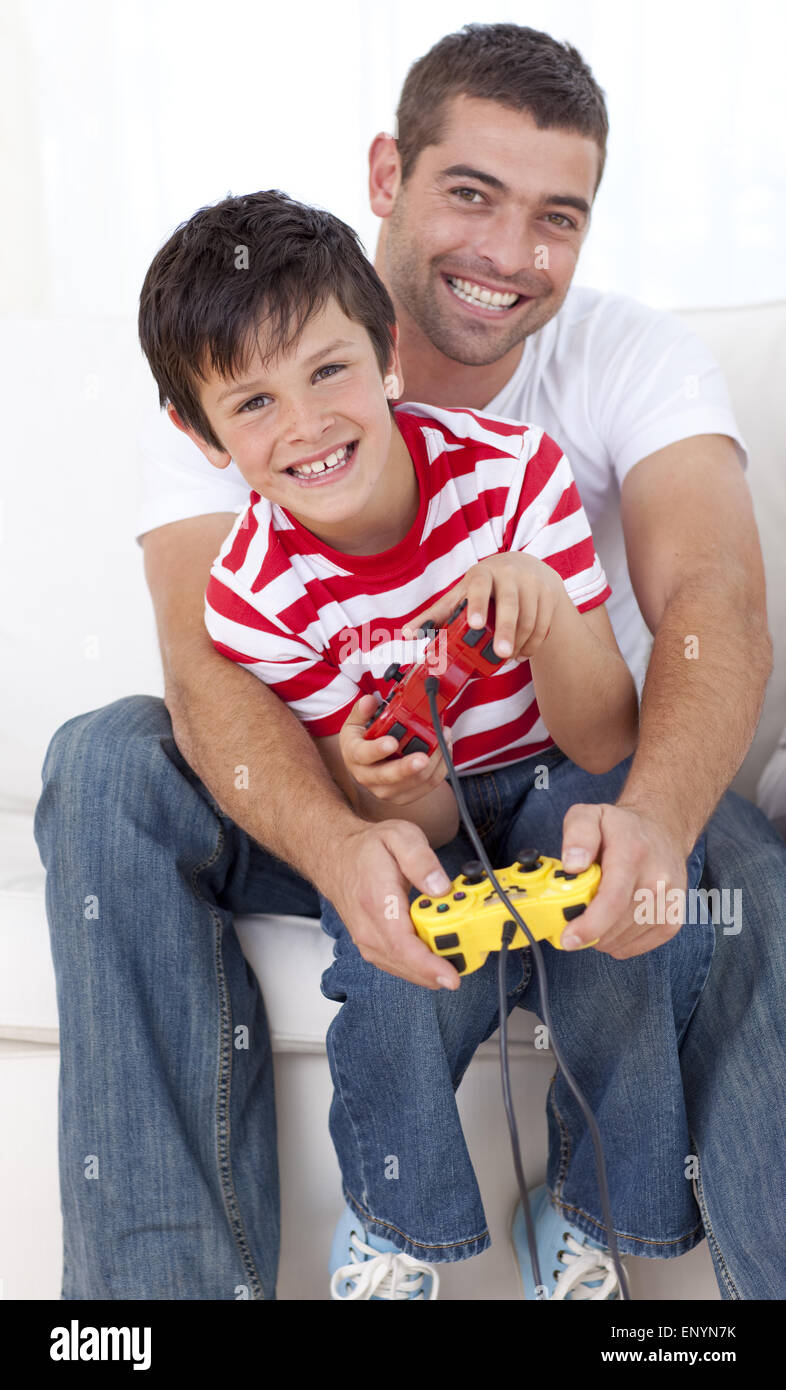 Father and son playing video games at home Stock Photo - Alamy