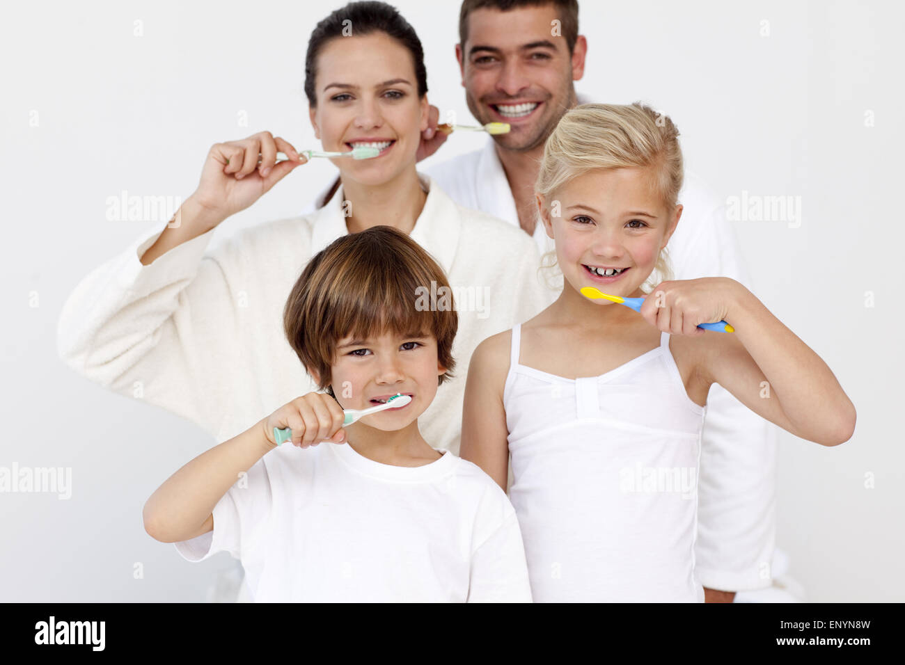 Portrait of happy family cleaning their teeth in bathroom Stock Photo ...