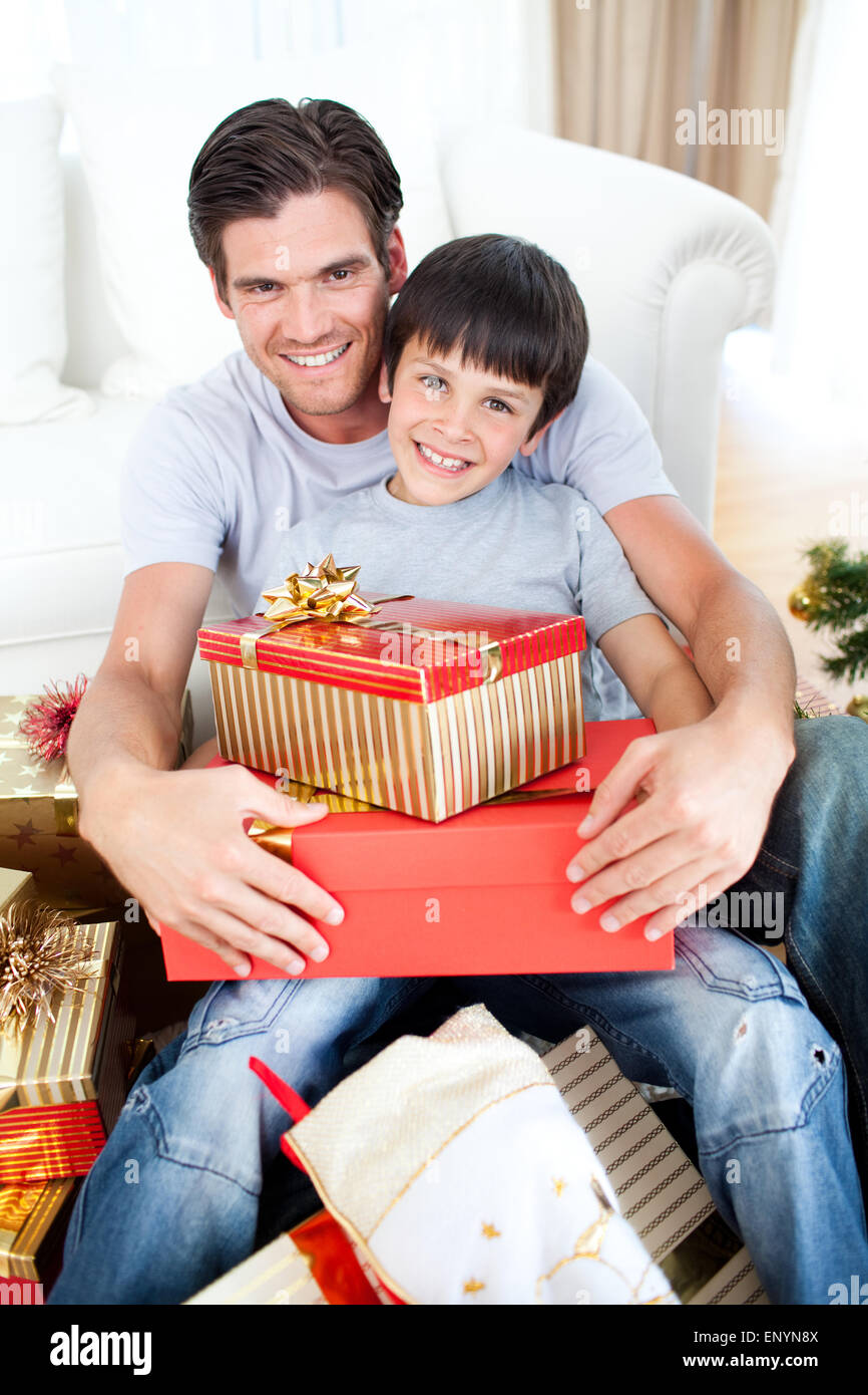 Happy father and son holding Christmas gifts Stock Photo - Alamy