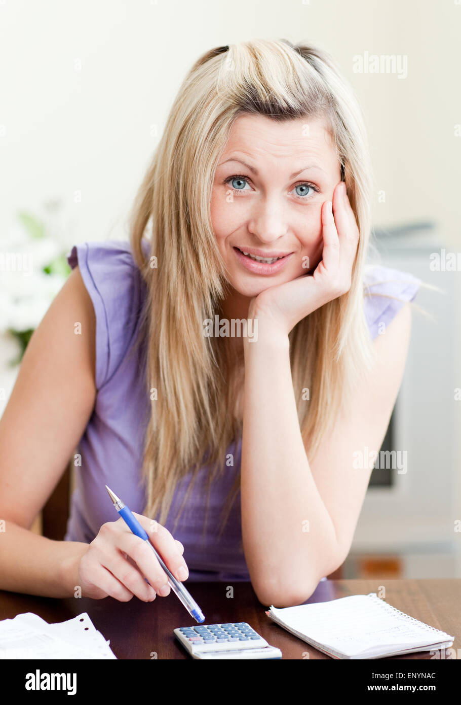 Portrait of a cheerful woman paying her bills Stock Photo - Alamy