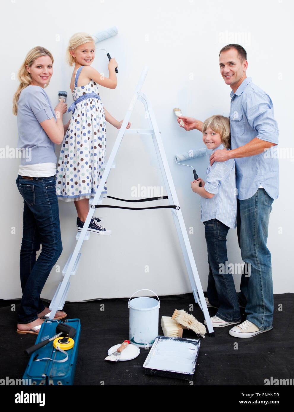 Happy Family decorating their new home together Stock Photo - Alamy