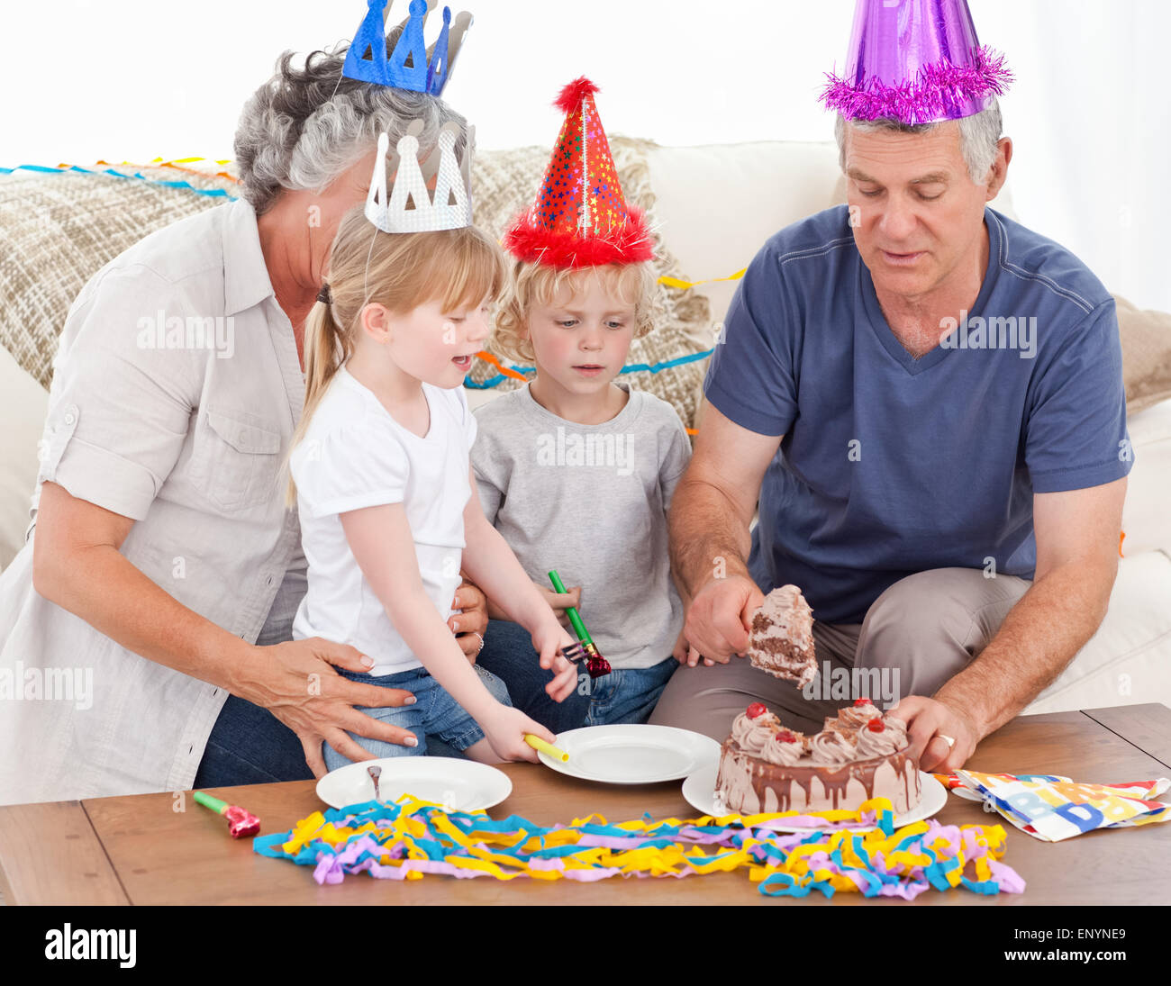 Family eating the birthday cake together Stock Photo - Alamy
