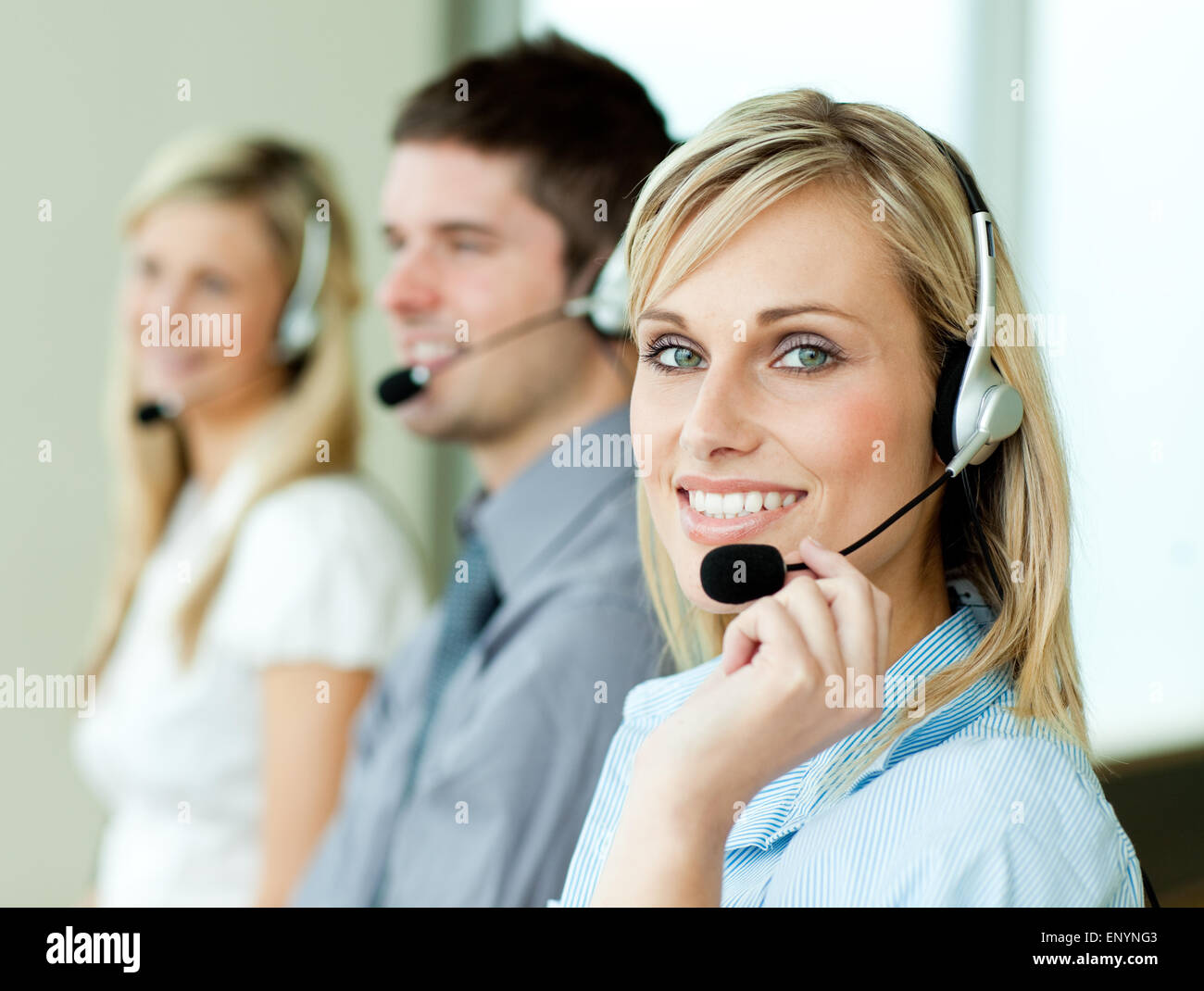 Three businesspeople working with headsets Stock Photo - Alamy