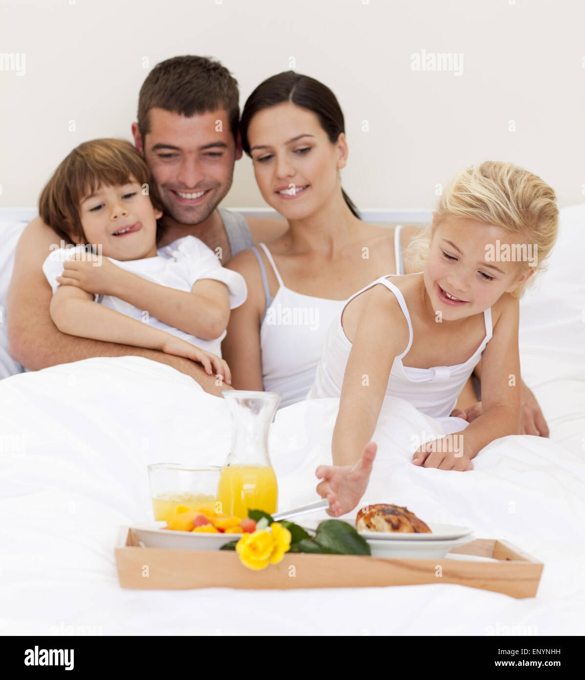 Happy family having breakfast in bedroom Stock Photo - Alamy