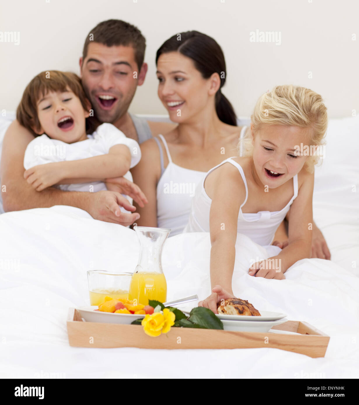 Family having breakfast in bed in the morning Stock Photo - Alamy