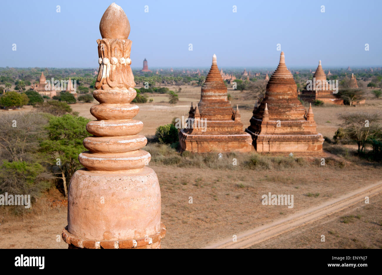 Detail of a stone spire with many temples in the background in Bagan ...