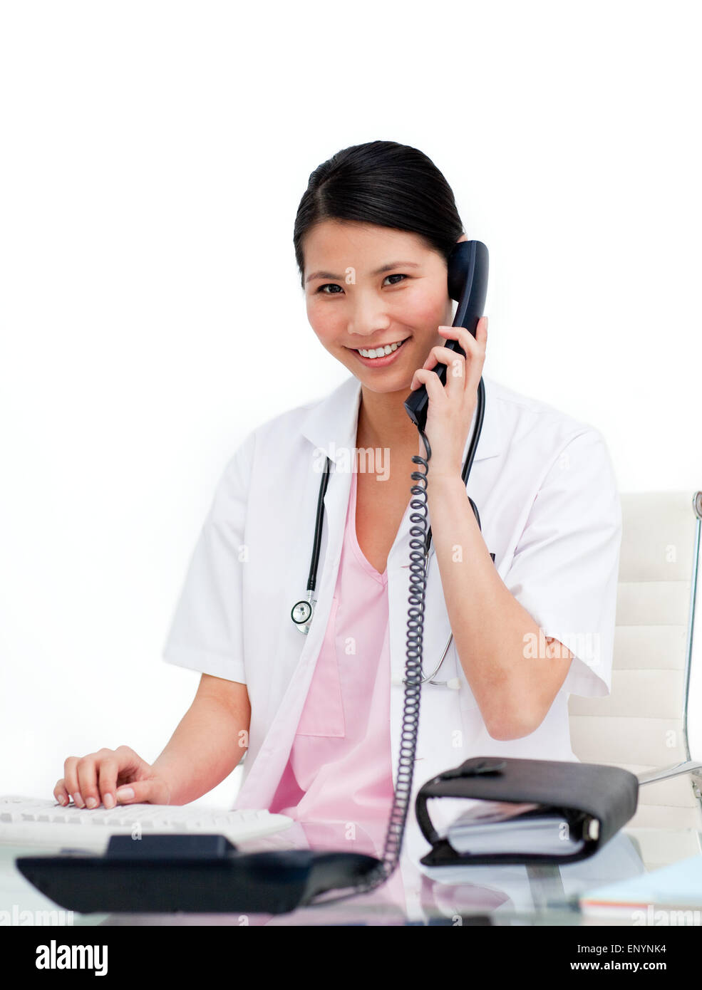 Asian doctor talking on phone against a white background Stock Photo ...
