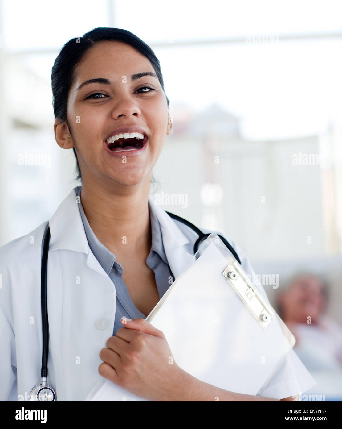 Laughing doctor holding a medical clipboard Stock Photo - Alamy
