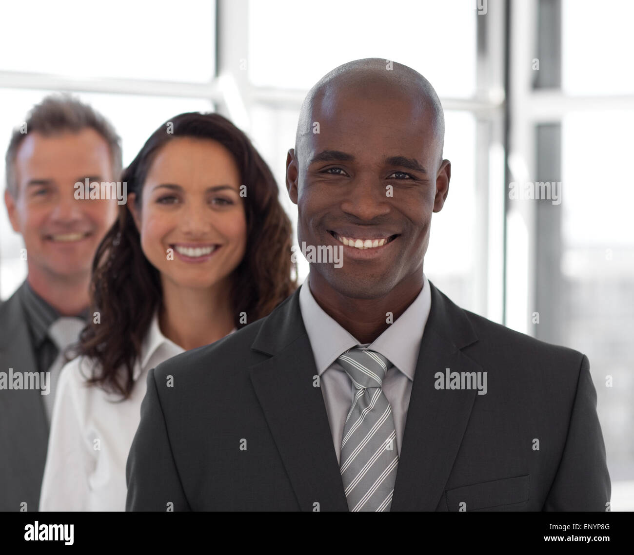 Five person Business team looking at camera and smiling Stock Photo - Alamy