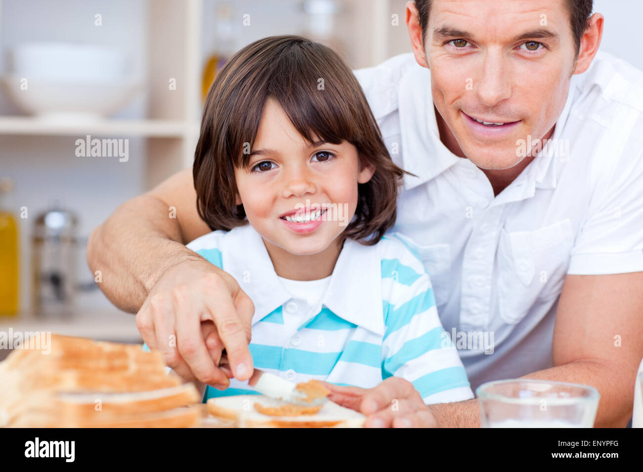 Portrait of a father and his son spreading jam on bread Stock Photo - Alamy